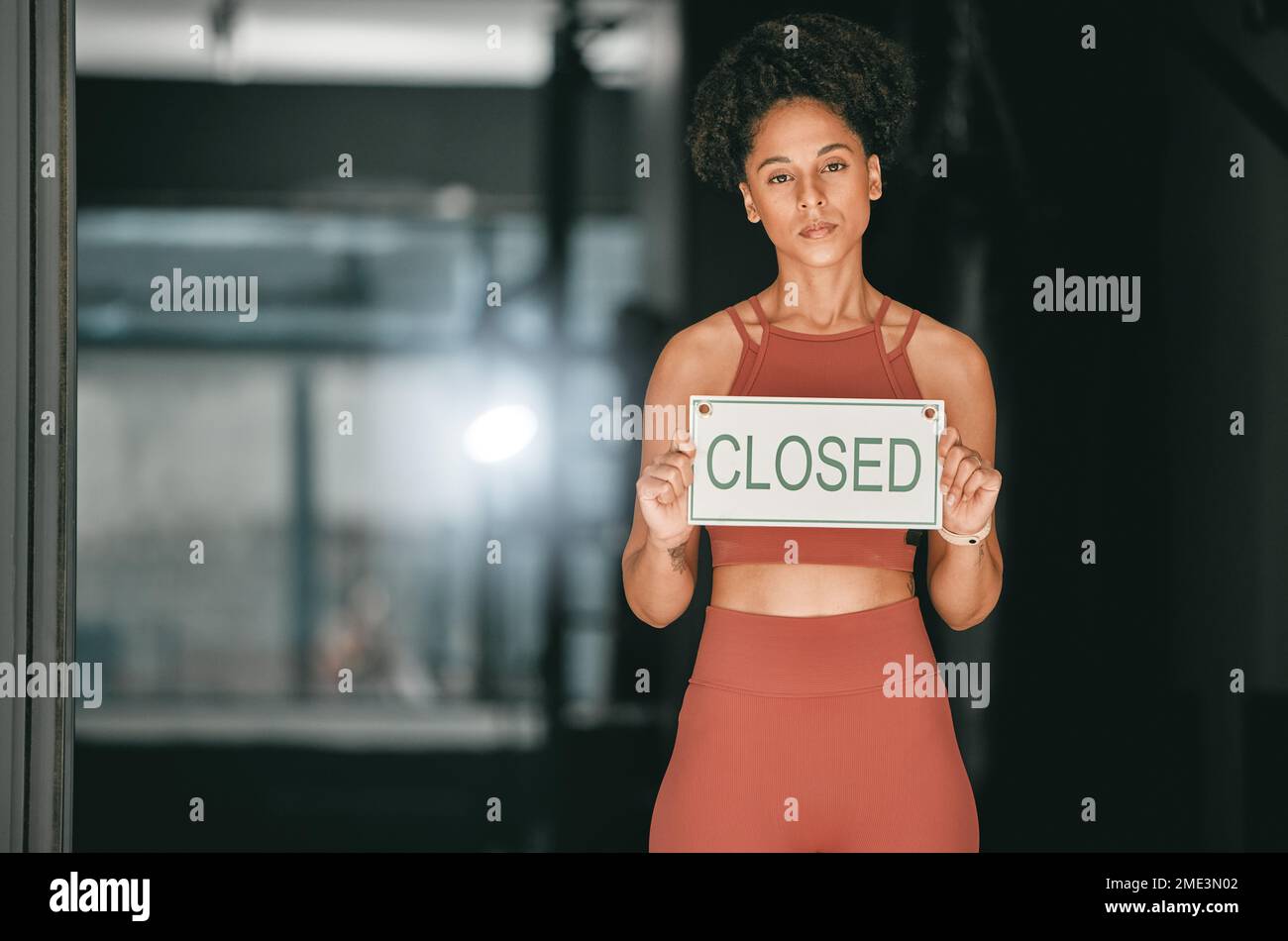 Fitness, portrait or personal trainer at gym with a closed sign for ...