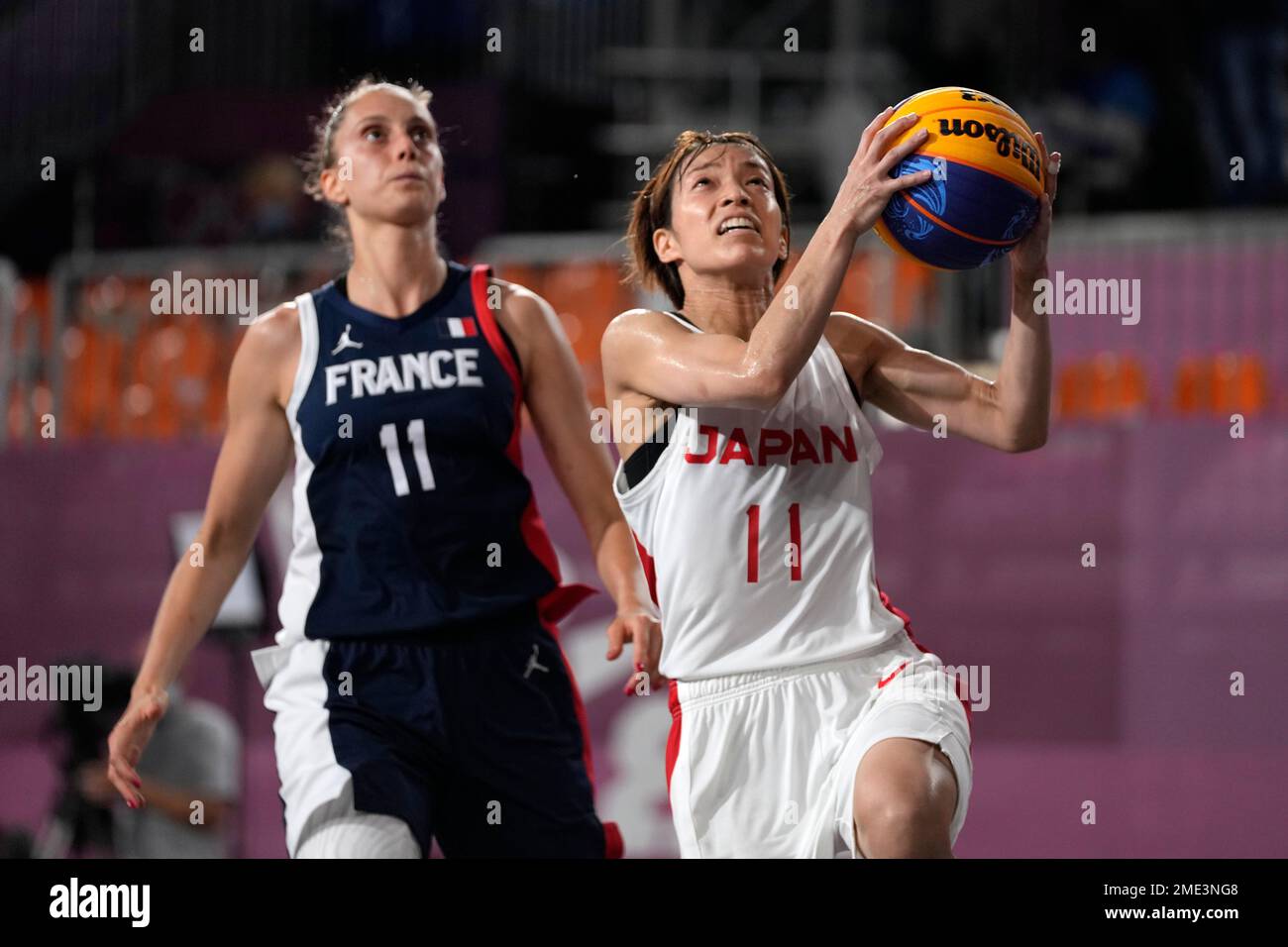 Japan's Mio Shinozaki, right, heads to the basket past France's Ana ...