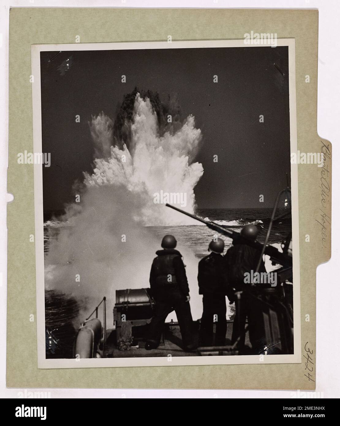 Coast Guardsmen aboard a U.S. vessel deploy a depth charge in the ...