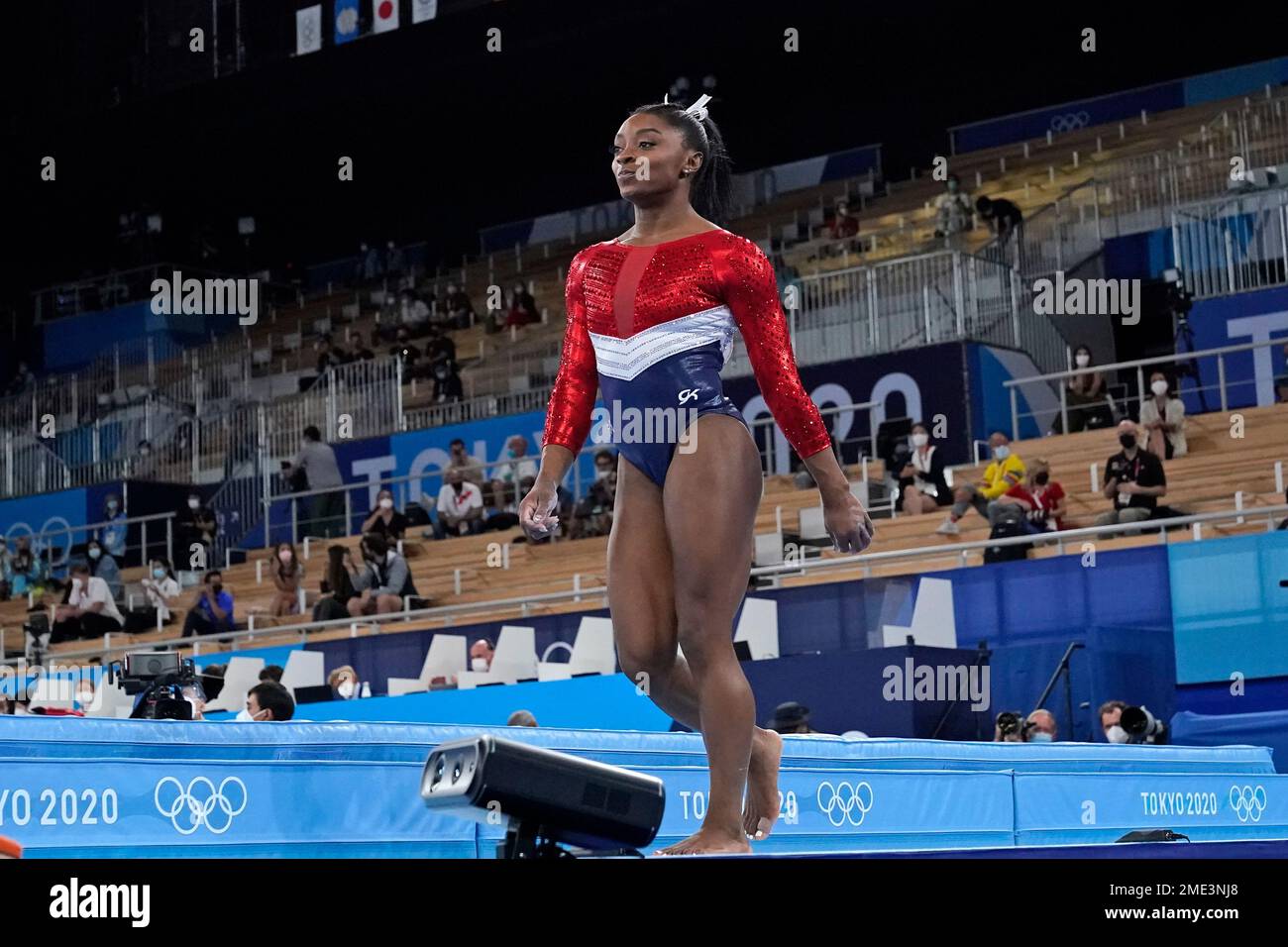 Simone Biles, of the United States, walks after performing on the vault ...