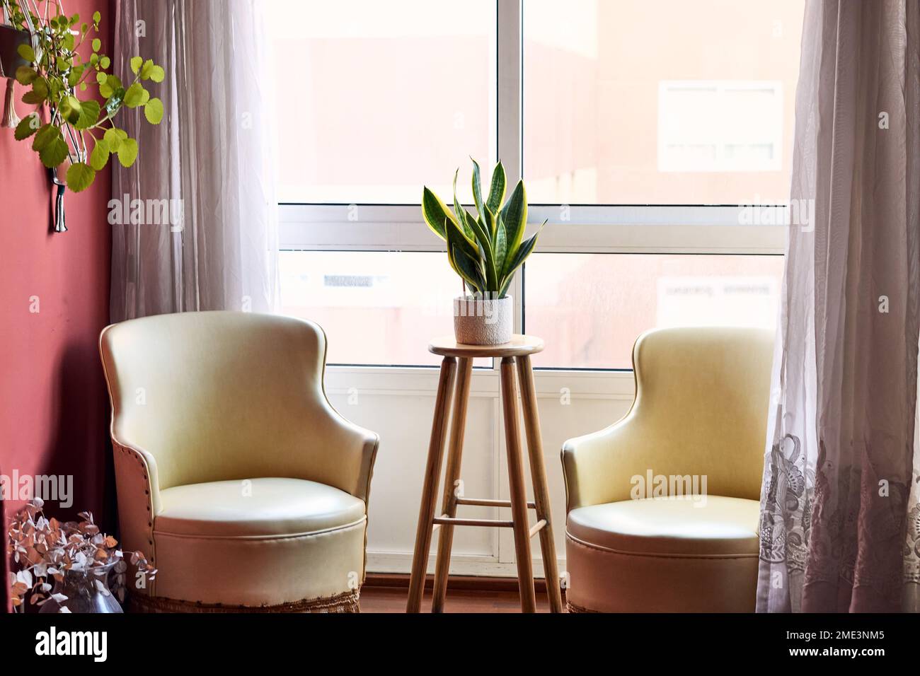 Rest space with armchairs, plants and a stool Stock Photo - Alamy