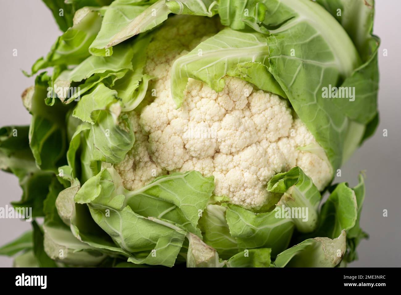 Whole cauliflower close-up on a light background. Vegetarian concept ...