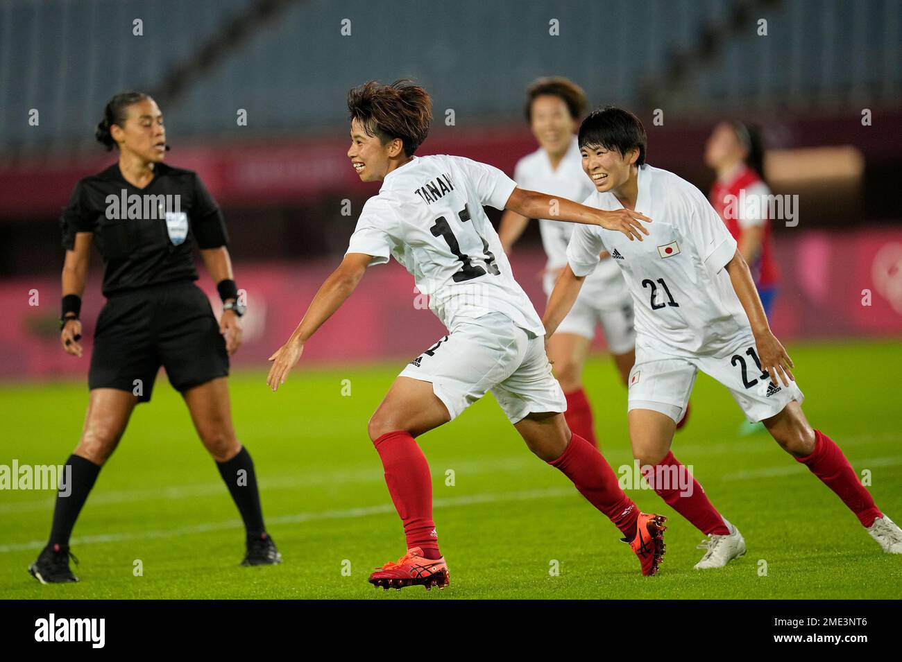 Japan's Mina Tanaka, center, celebrates scoring her side's opening goal ...