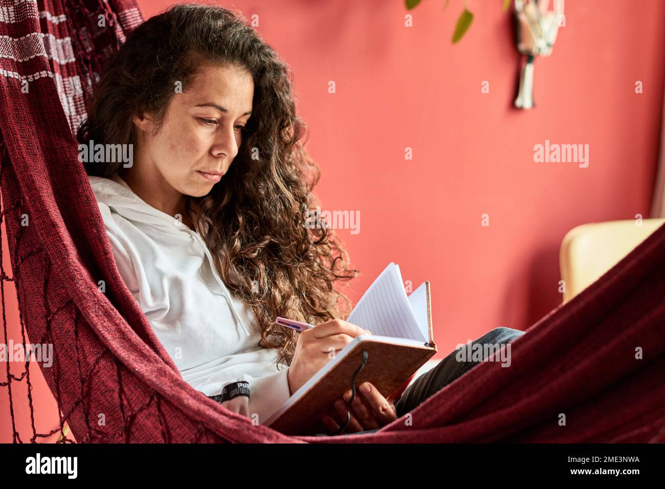 Woman writing in a hammock Stock Photo - Alamy