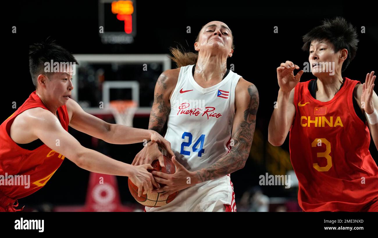 Puerto Rico's Jazmon Gwathmey (24) drives between China's Yuan Li (4) and Liwei Yang (3) during ...