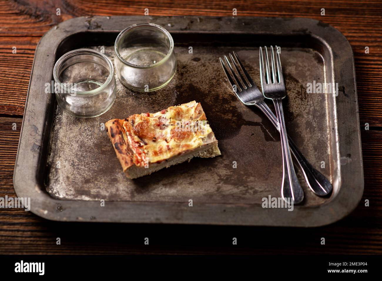 One piece of pizza on an old tray. Last piece. Diet, food restriction ...
