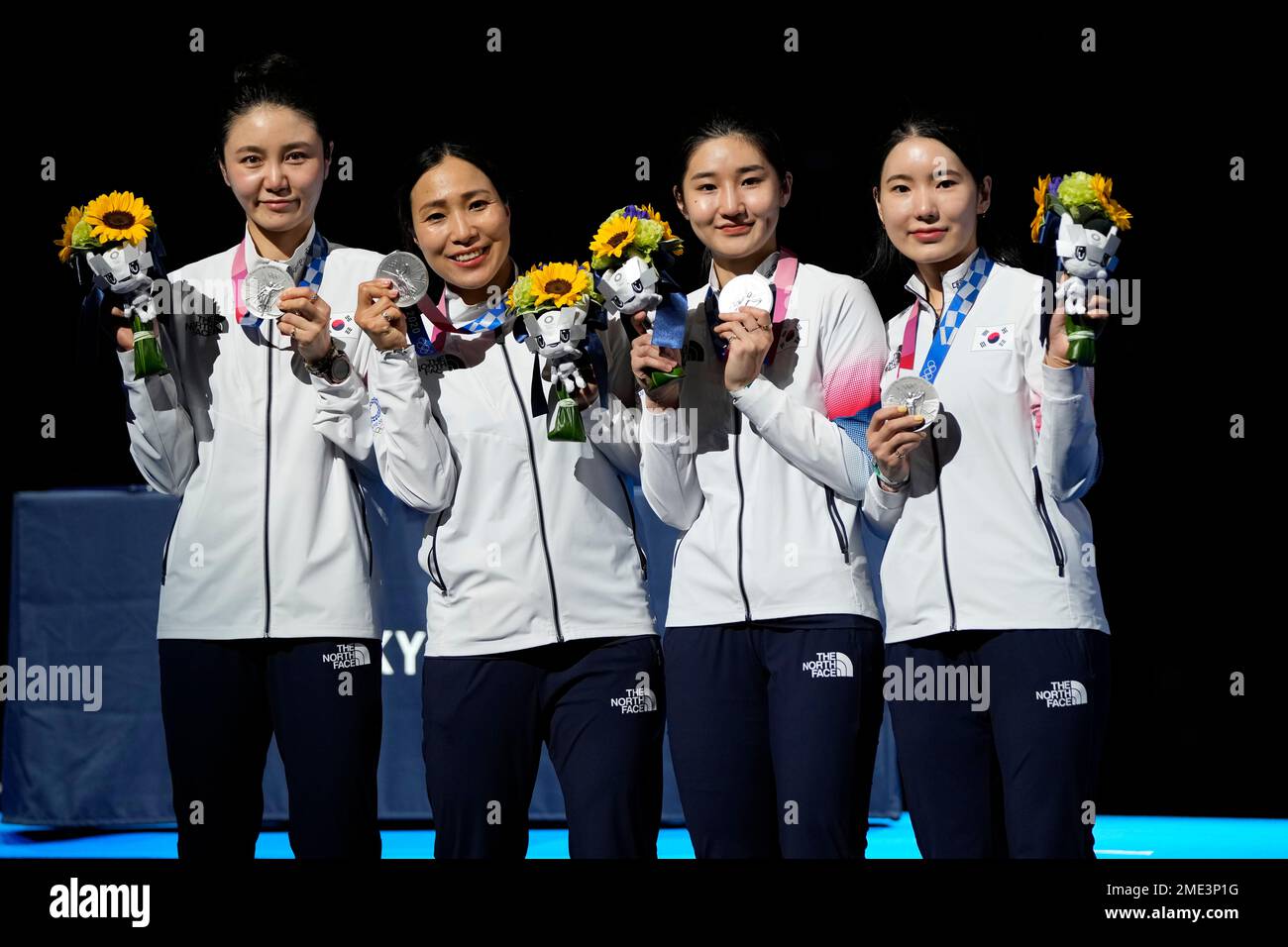 South Korea Epee team celebrate on the podium during the medal ceremony ...