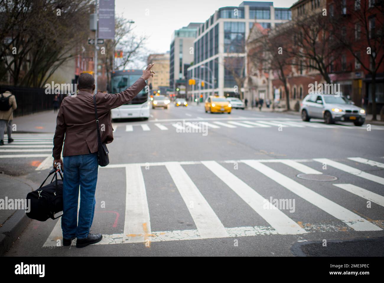 Person raising their arm to hail a yellow cab in New York City Stock ...
