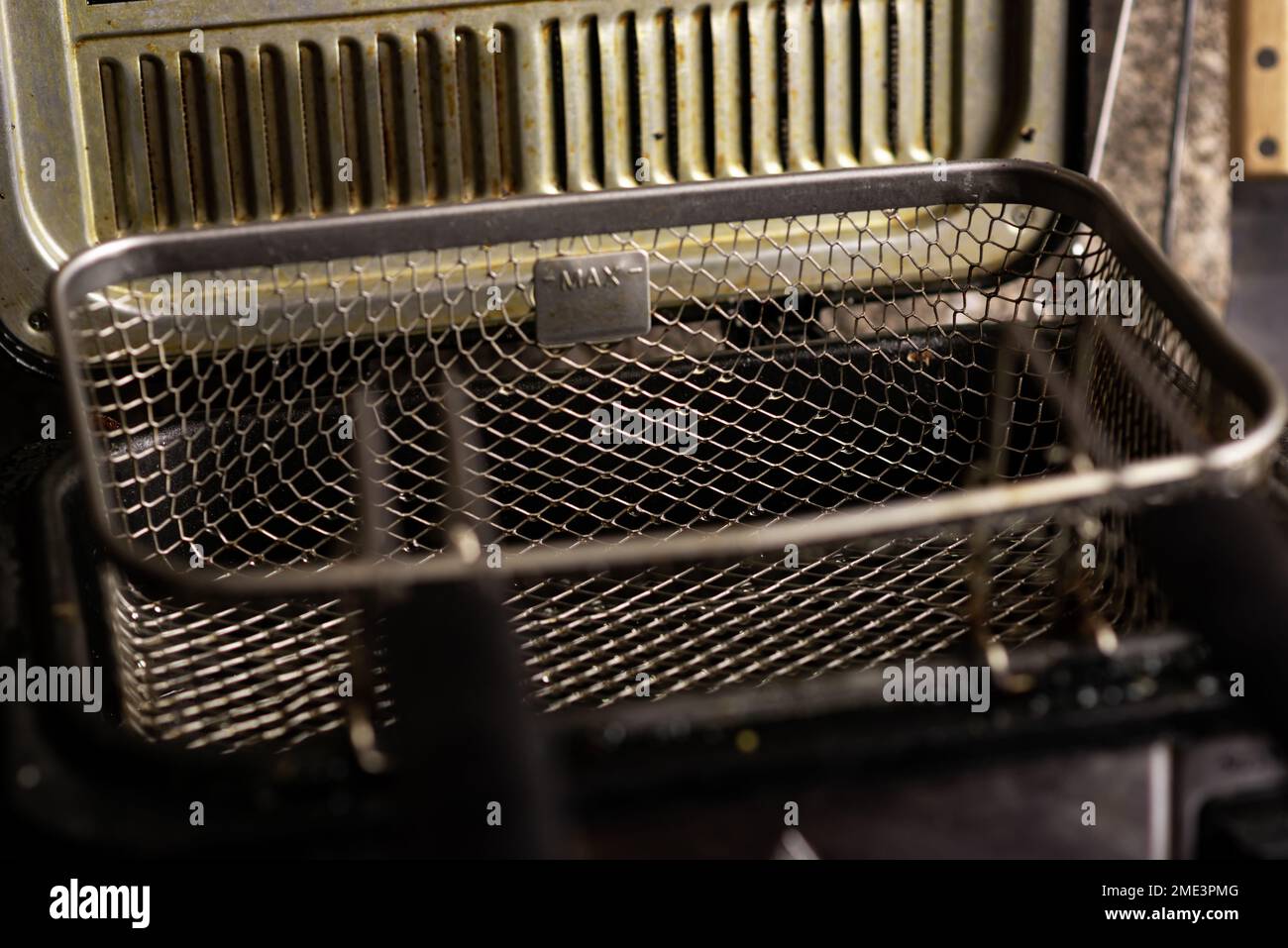 Empty dirty deep fryer basket. Preparation for cooking Stock Photo - Alamy