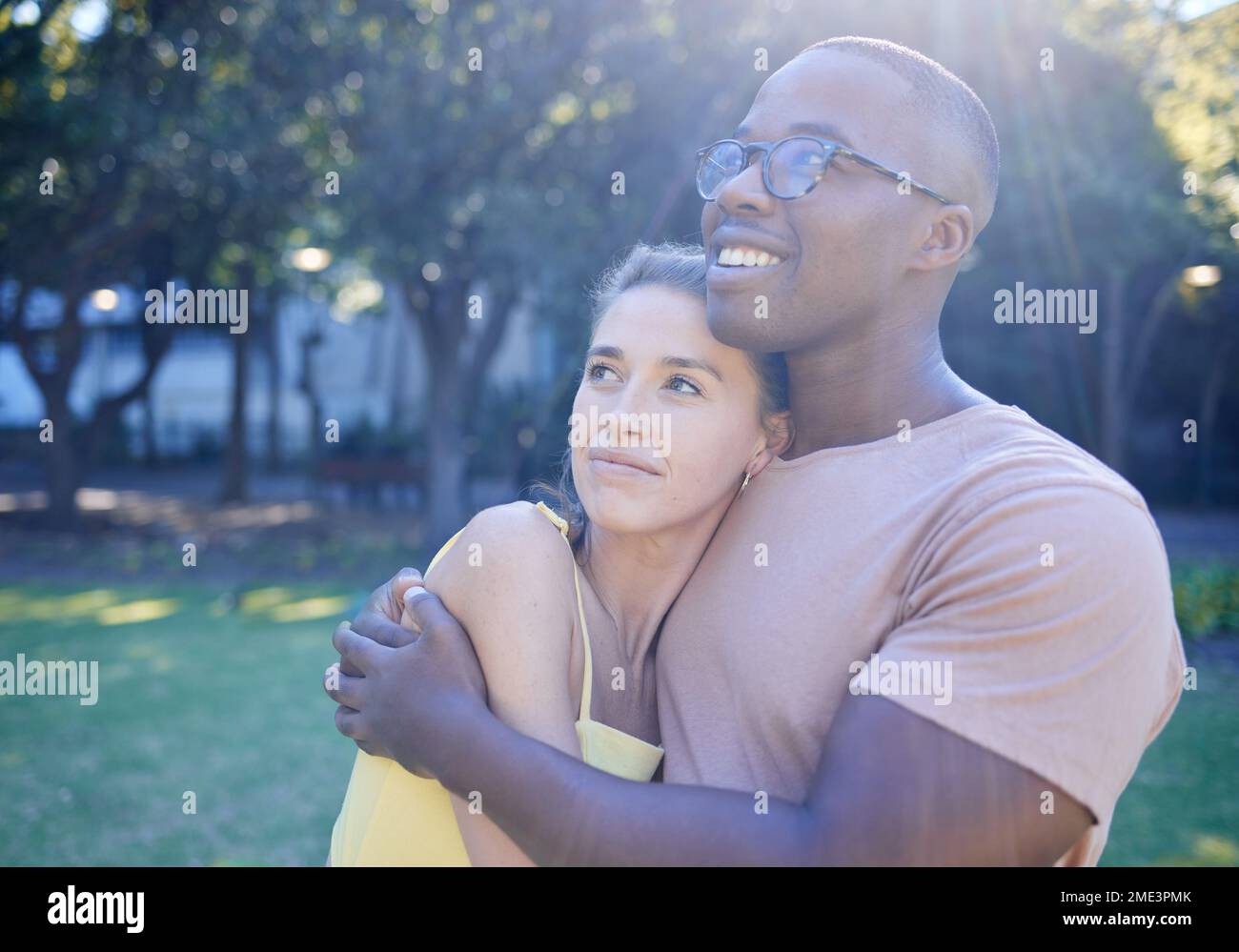 Interracial Couple Hug And Park With Smile Thinking Or Love For
