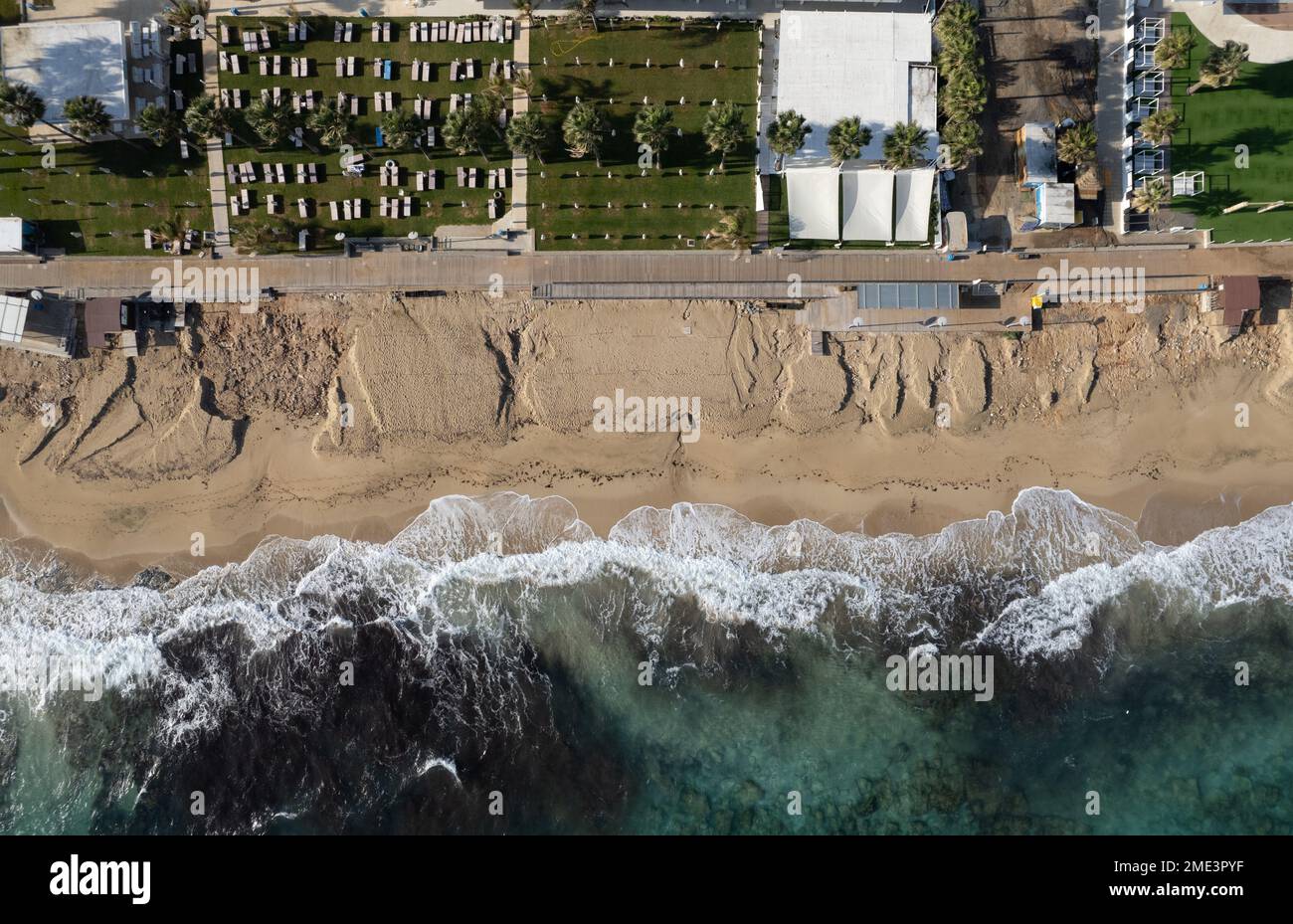 Aerial view of ocean waves breaking on a sandy beach. Beach erosion ...