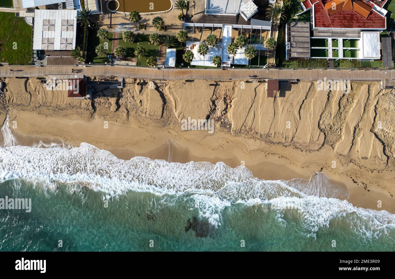 Aerial view of ocean waves breaking on a sandy beach. Beach erosion ...