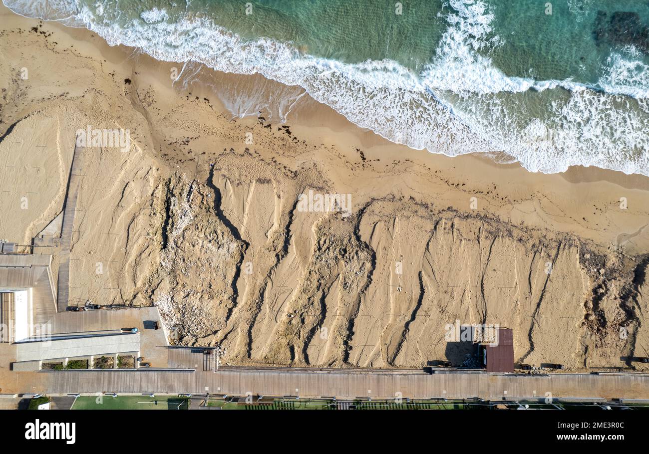 Aerial view of ocean waves breaking on a sandy beach. Beach erosion ...