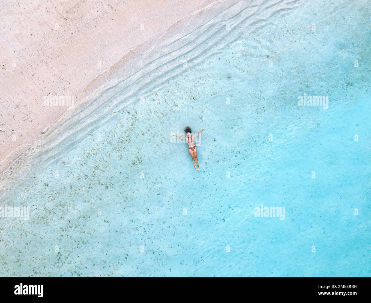 Woman relaxing and swimming in sea at beach Stock Photo - Alamy