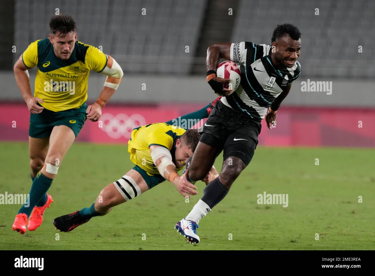 Fiji's Jerry Tuwai evades a tackle attempt by Australia's Nick Malouf ...
