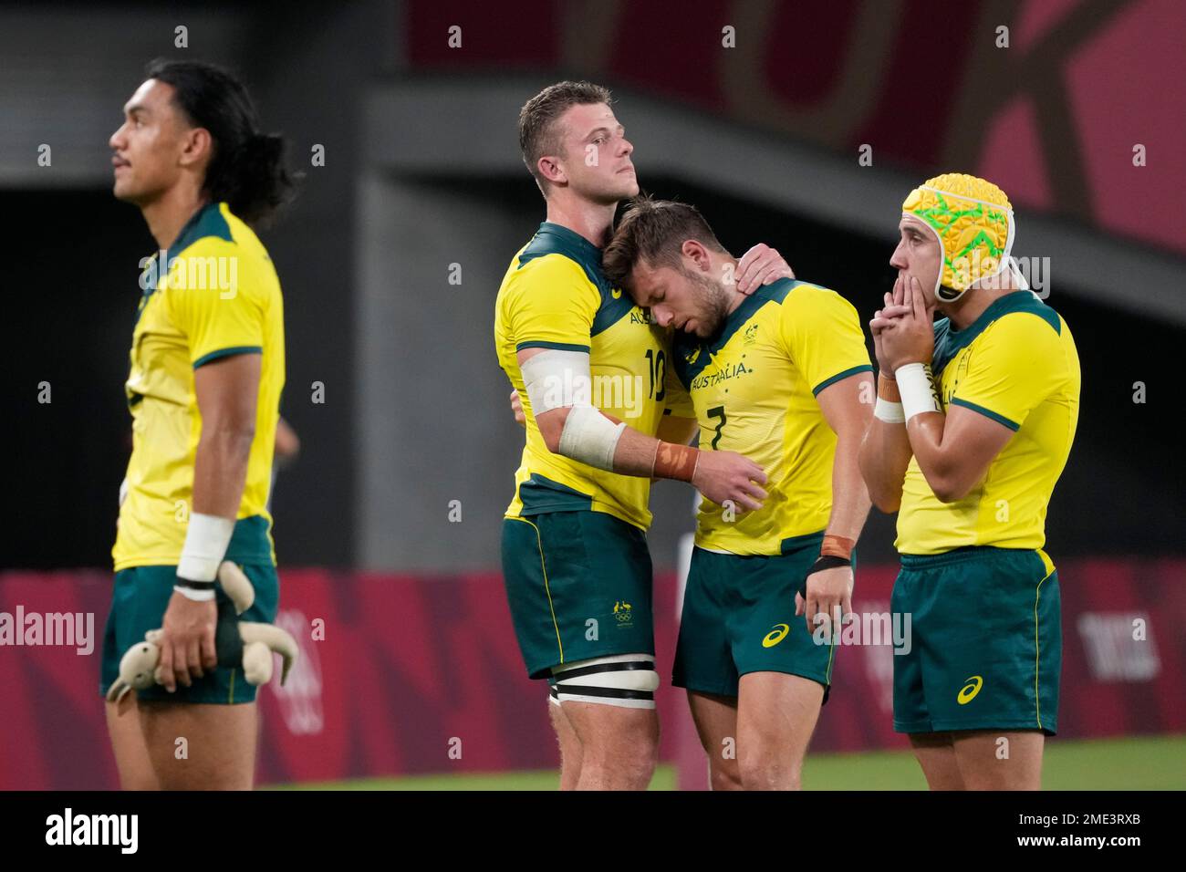 Australia's Nick Malouf, center left, and teammate Josh Turner embrace ...