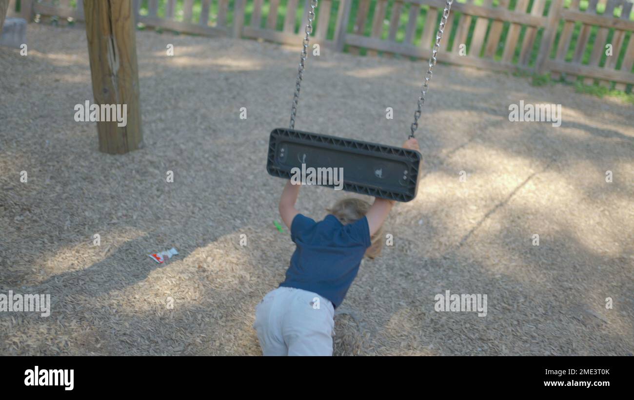 Child falling from playground swing kid falls down Stock Photo - Alamy