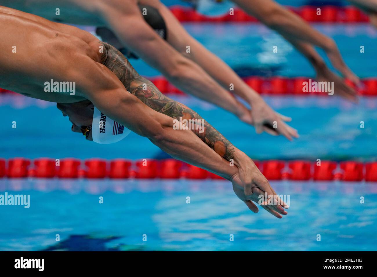 Caeleb Dressel, of the United States, swims in a heat of the men's 100 ...