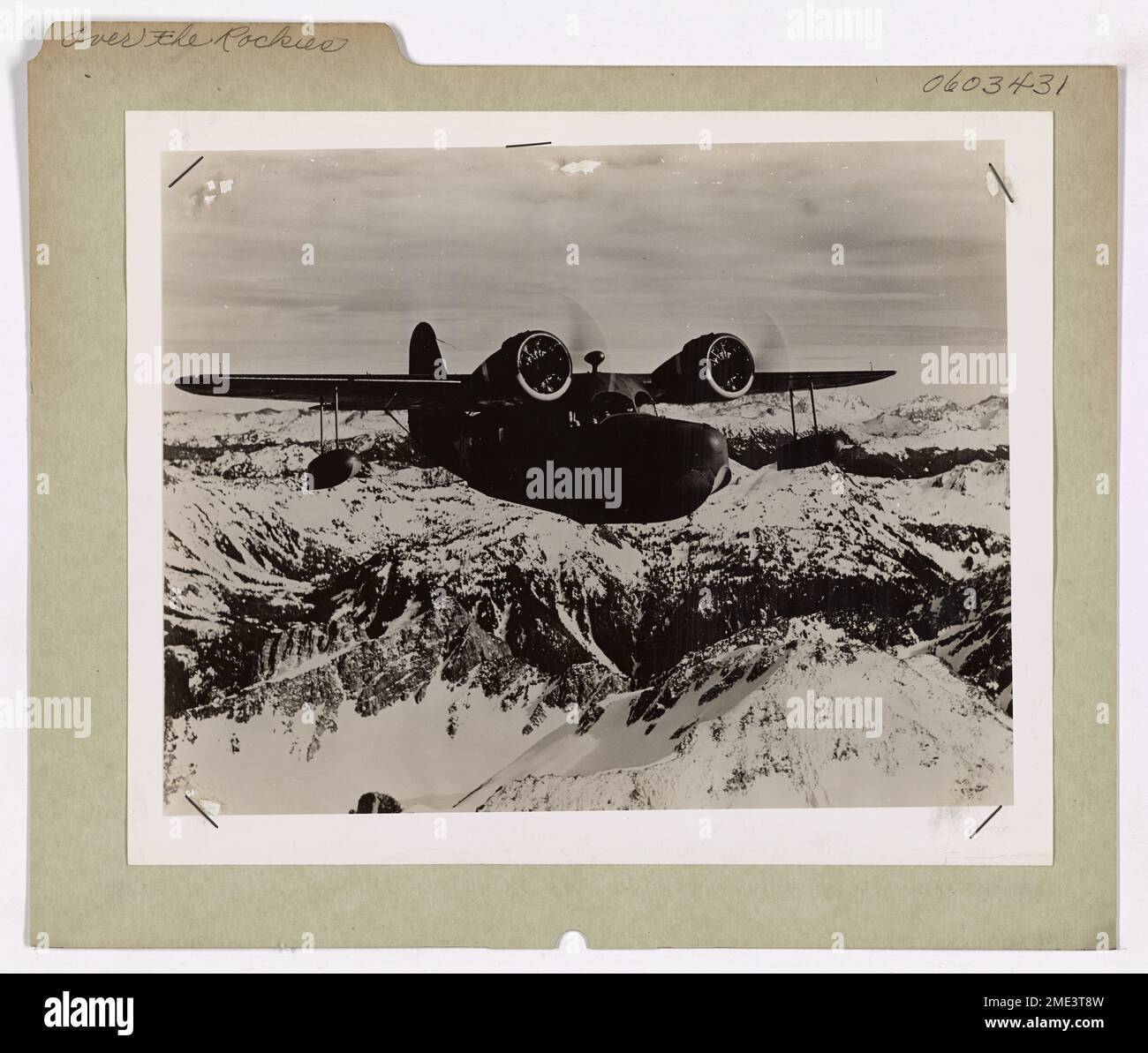A U.S. Coast Guard plane is shown flying over the Rocky Mountains ...