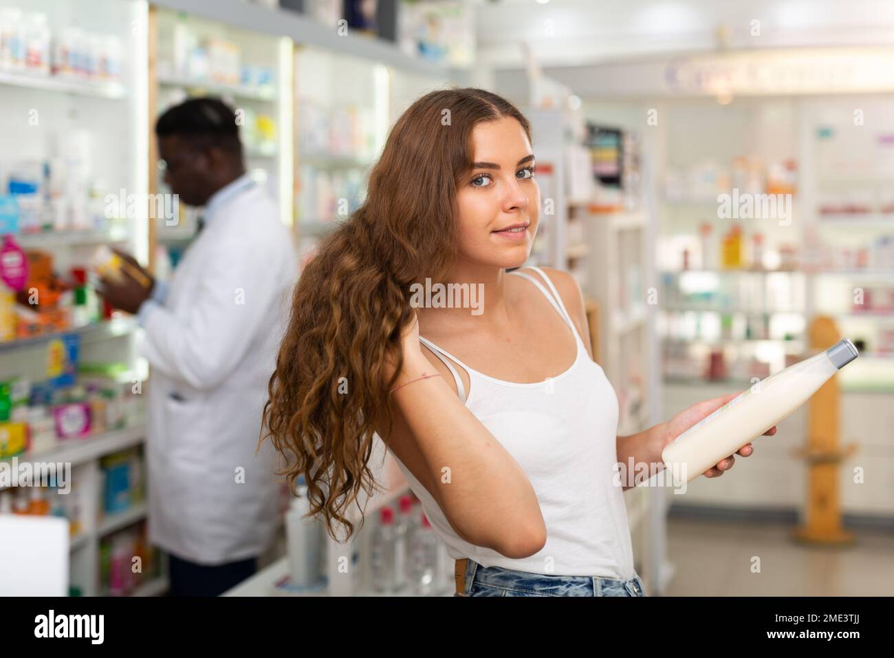 Young lady choosing haircare products Stock Photo - Alamy