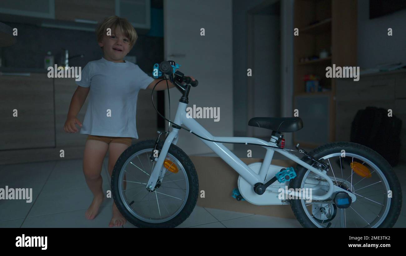 Child waking up to suprise bicycle gift in the morning. Excited little ...