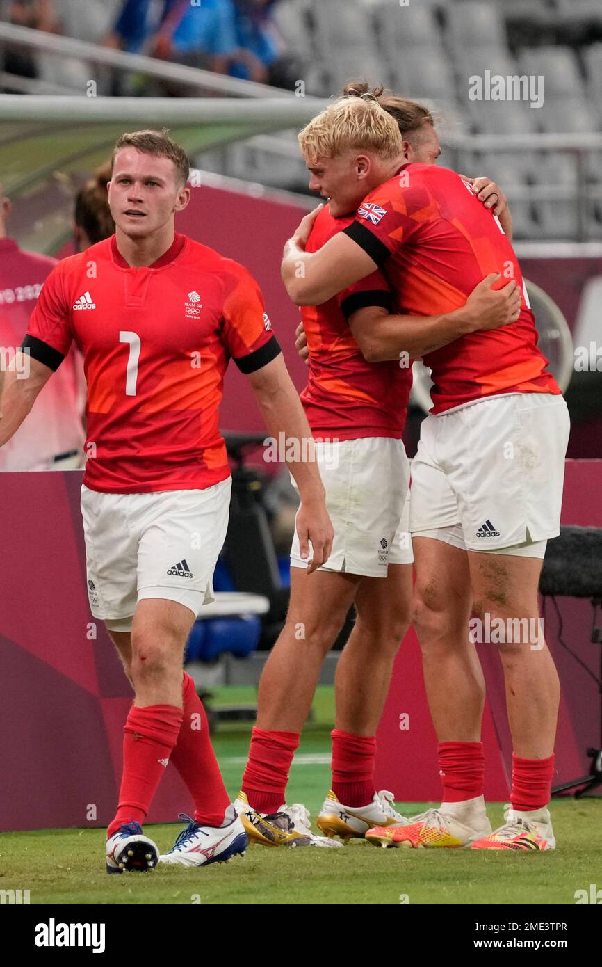 Britain's Ben Harris, right, hugs teammate Britain's Dan Bibby, as ...