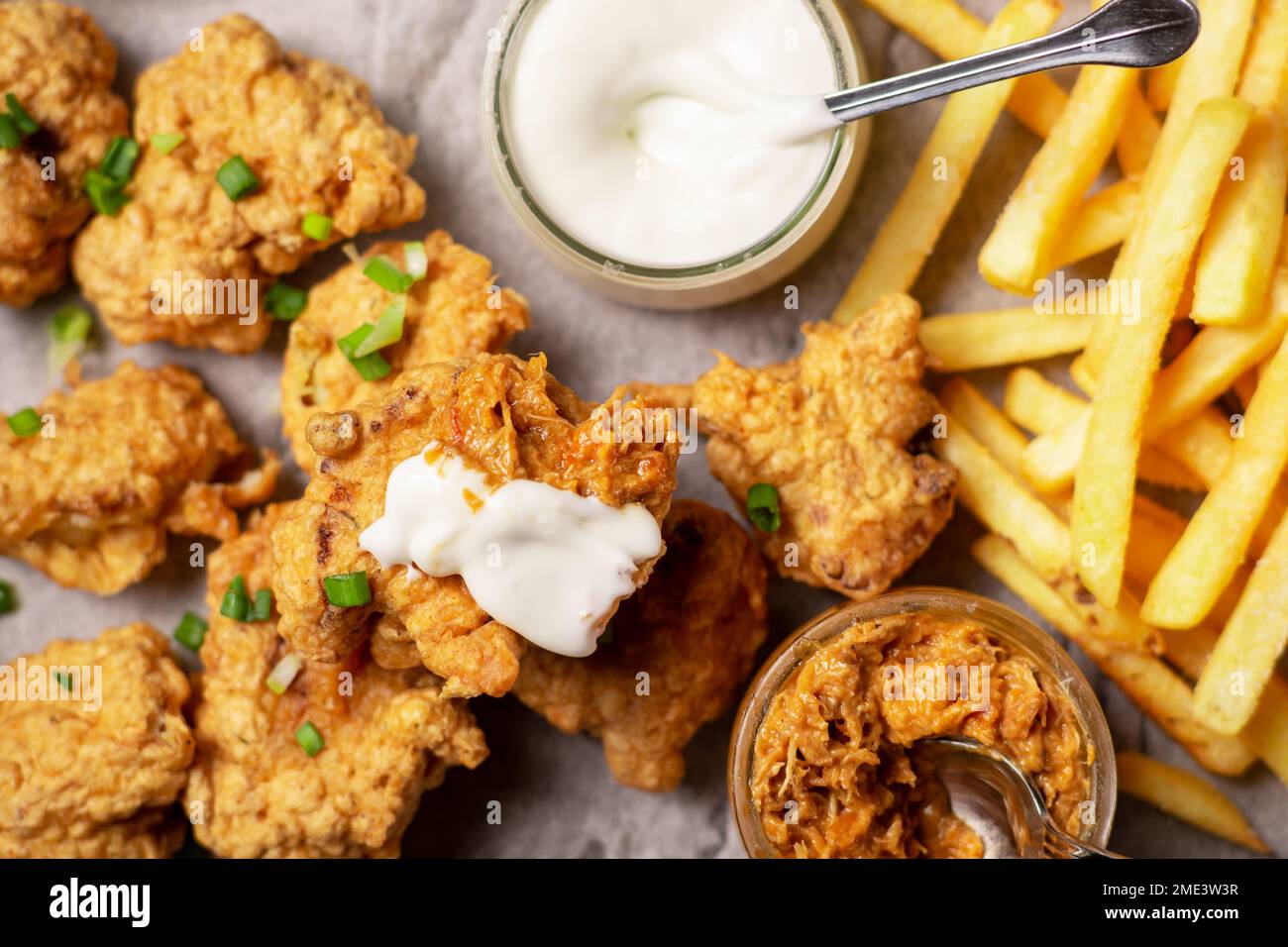 Cauliflower wings food. Cauliflower pieces and french fries with vegan ...