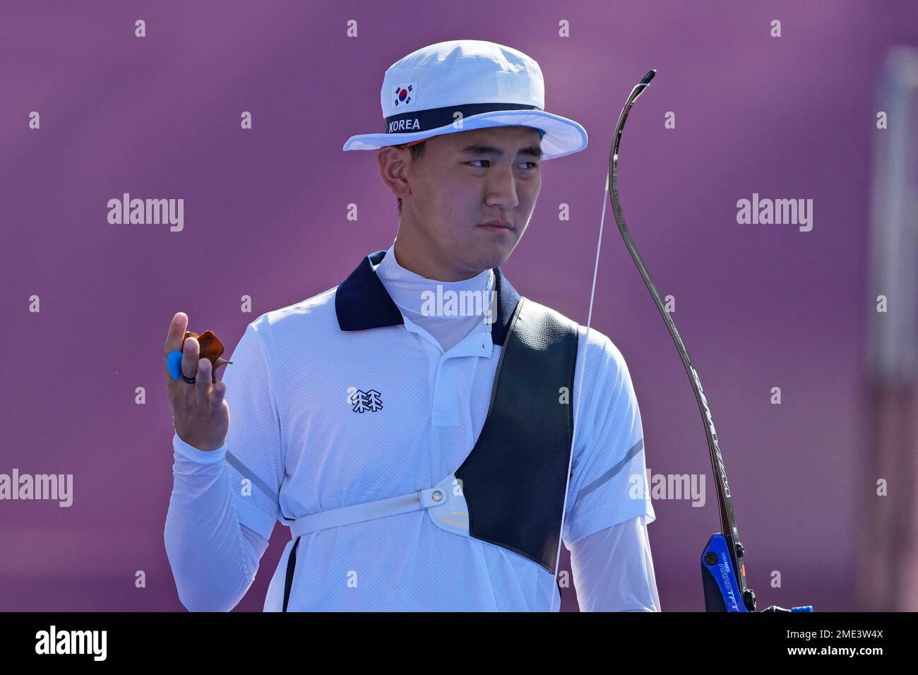 South Korea's Kim Je Deok looks at the target during the men's ...