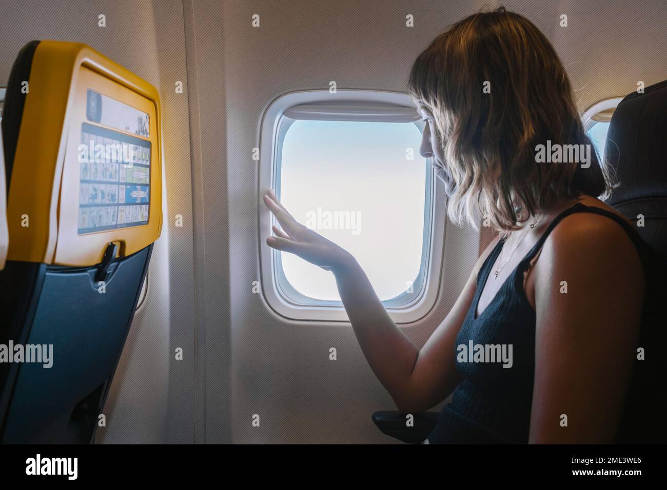 Airplane window and woman hi-res stock photography and images - Alamy
