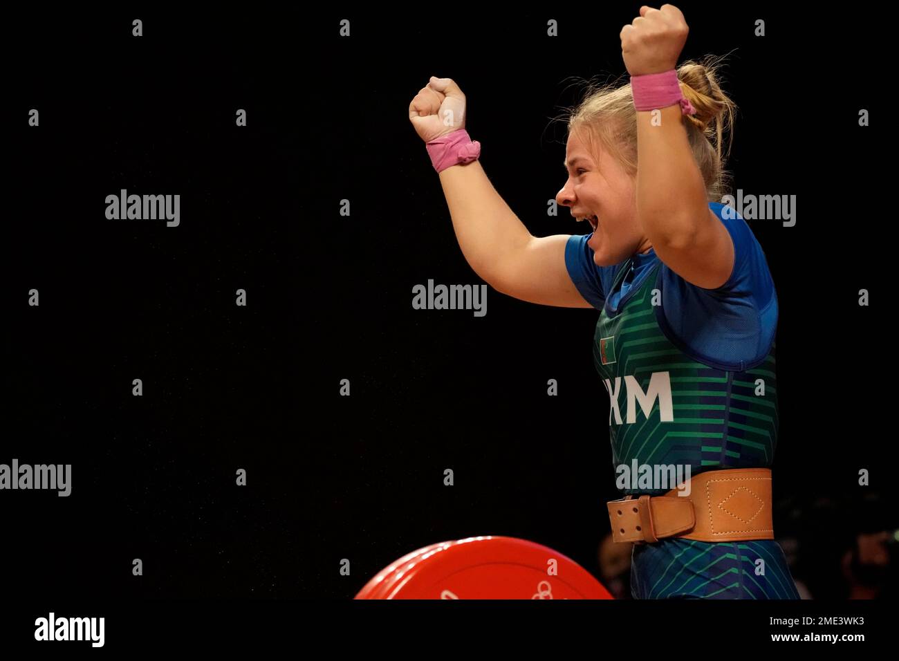 Polina Guryeva of Turkmekistan celebrates after the last lift as she ...