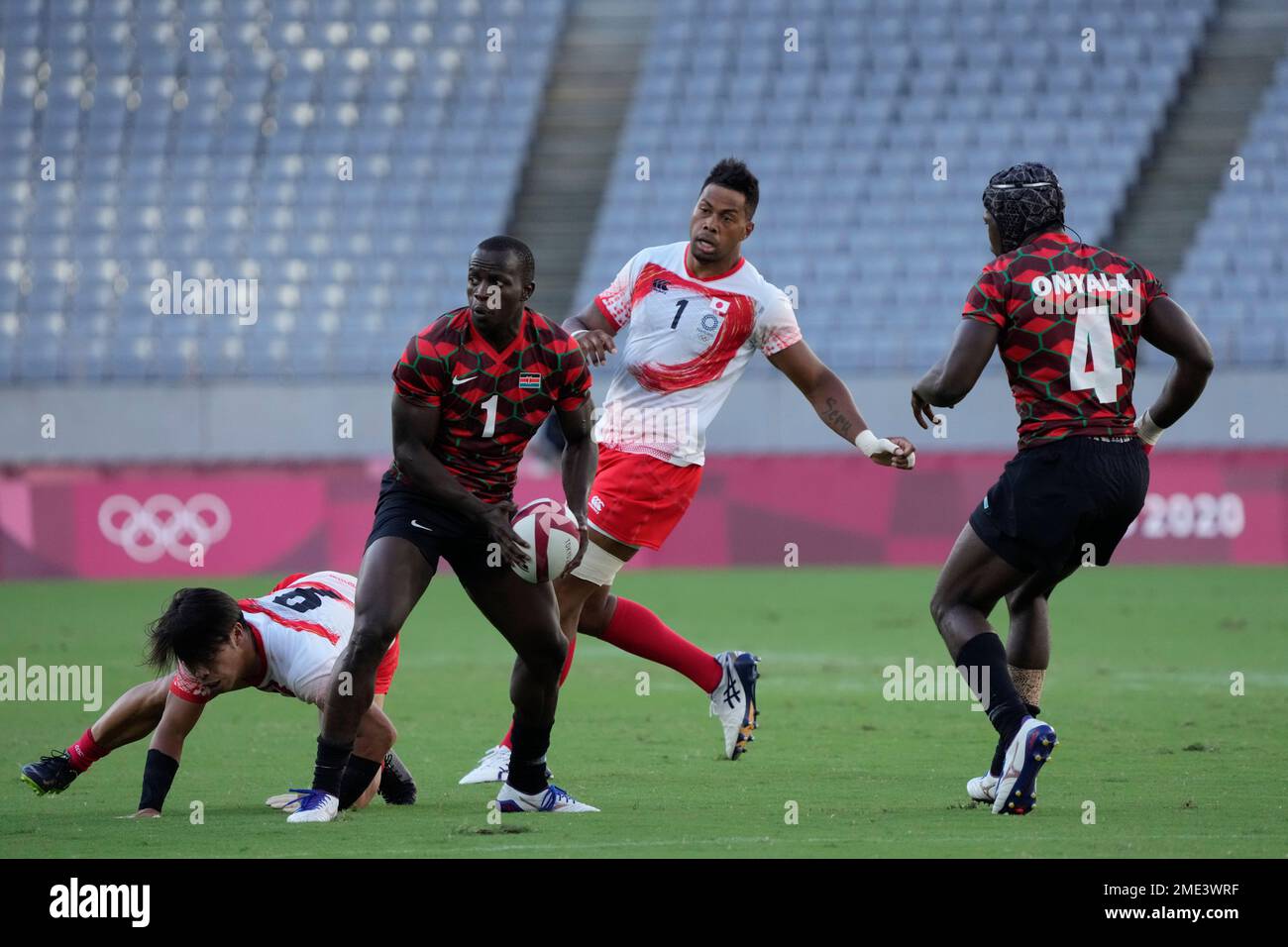 Kenya's Daniel Taabu looks to pass from amidst Japan's Ryota Kano, left ...