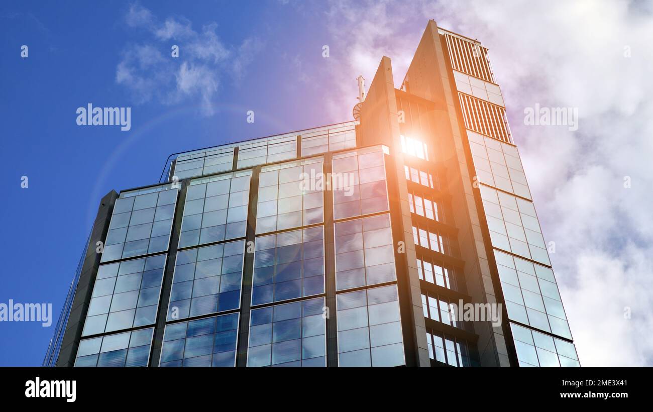 Modern glass facade against blue sky. Bottom view of a building in the ...
