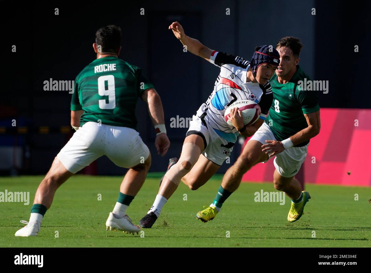 South Korea's Jang Jeong-min, center, is pressured by Ireland's Mark ...