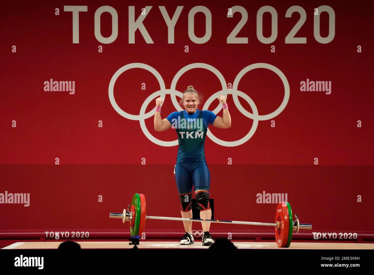 Polina Guryeva of Turkmekistan celebrates after a lift as she competes ...