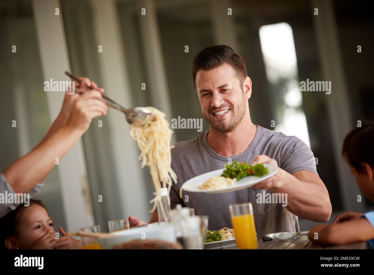 Theres always bright smiles around the dinner table. a family of four ...