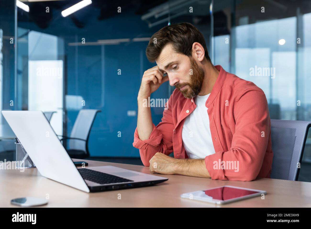 Frustrated businessman depressed at workplace working on laptop, man in ...