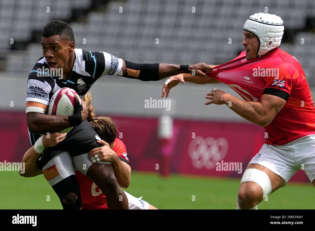 Fiji's Napolioni Bolaca, left, pulls the shirt of Britain's Ethan ...
