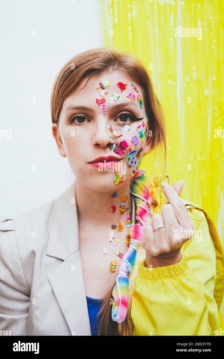 Woman with stickers on face gesturing heart shape Stock Photo - Alamy