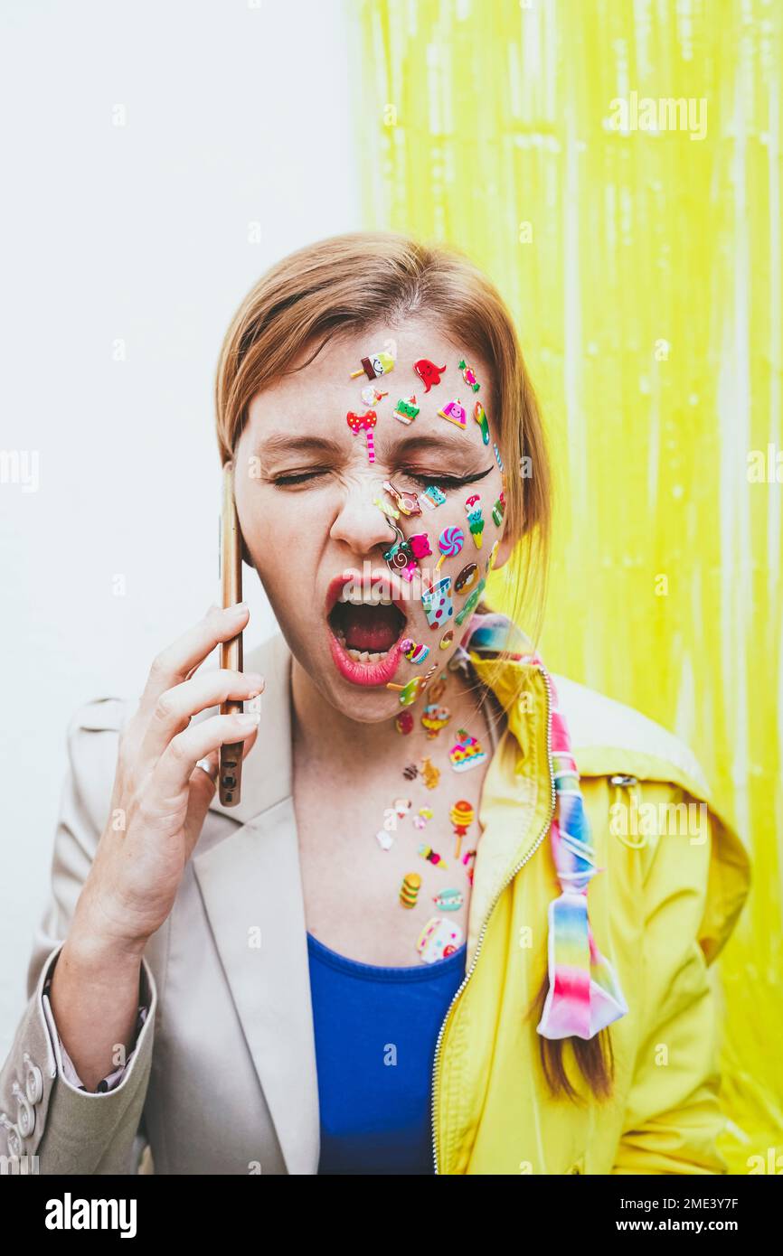 Angry woman shouting and talking through smart phone with stickers on ...