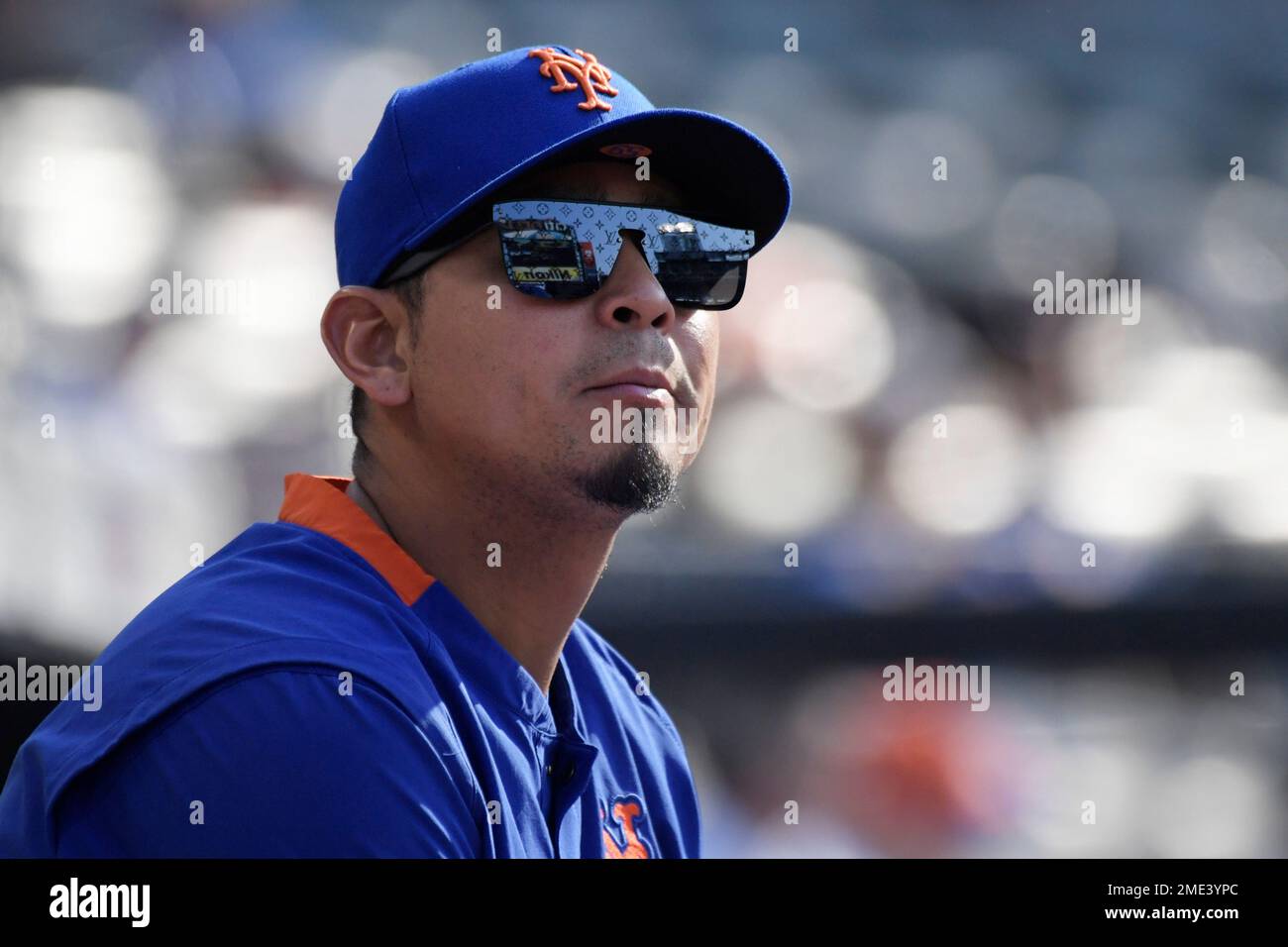 New York Mets pitcher Carlos Carrasco looks on from the dugout before ...