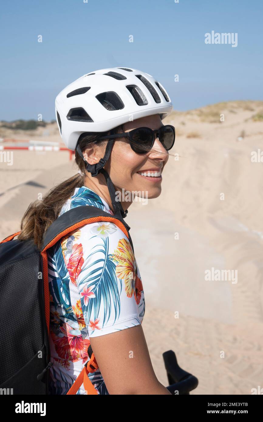 Happy cyclist wearing helmet on sunny day Stock Photo - Alamy