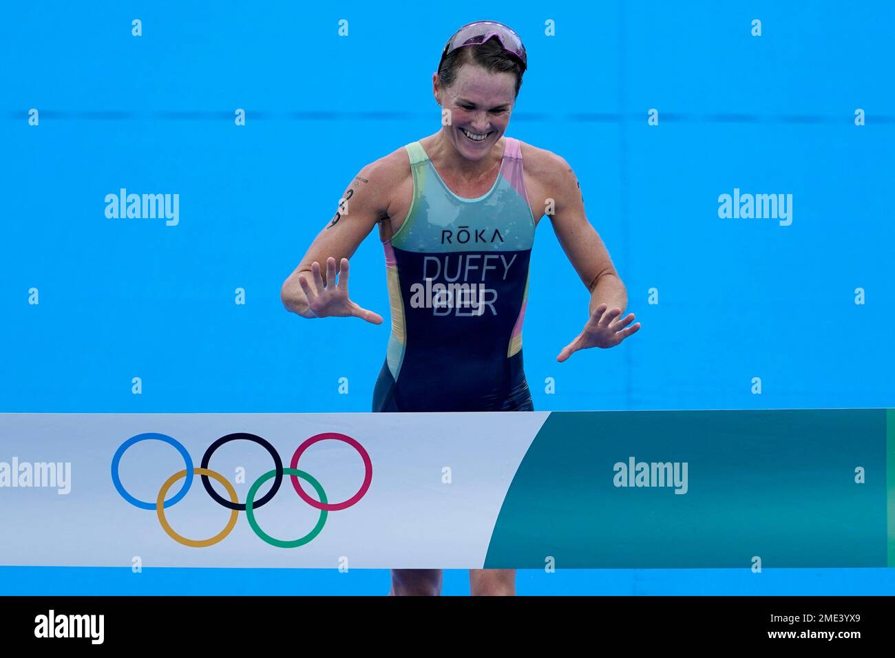 Flora Duffy, of Bermuda, celebrates while running to the finish line to ...