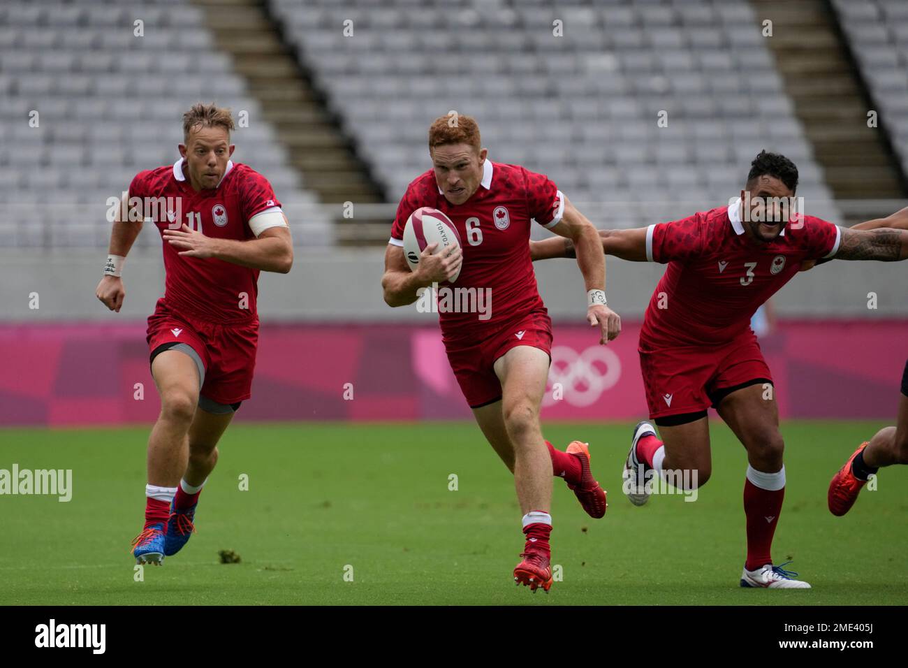 Canada's Connor Braid runs to score a try against Japan as teammates ...