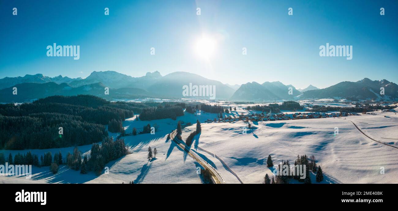 A panoramic aerial view of a forest landscape covered with snow and a ...