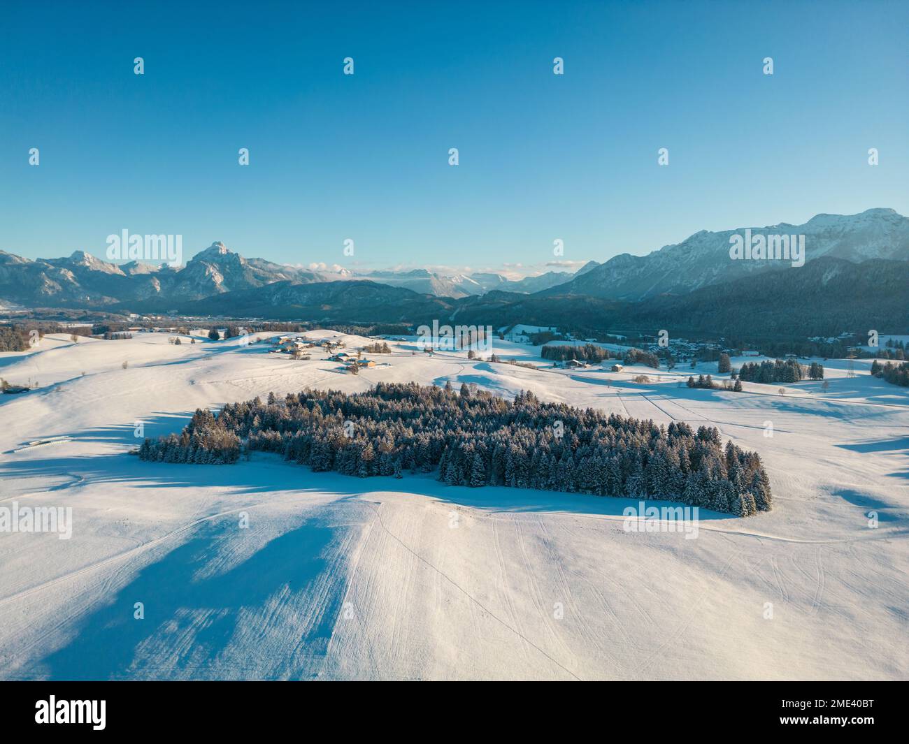 An aerial view of a forest landscape covered with snow and a mountain ...