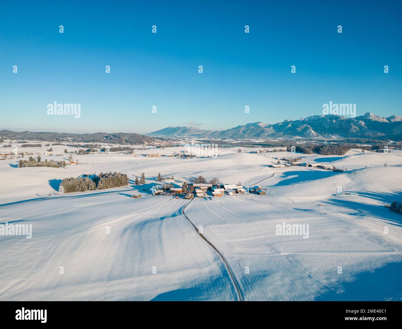 An aerial view of a forest landscape covered with snow and a mountain ...