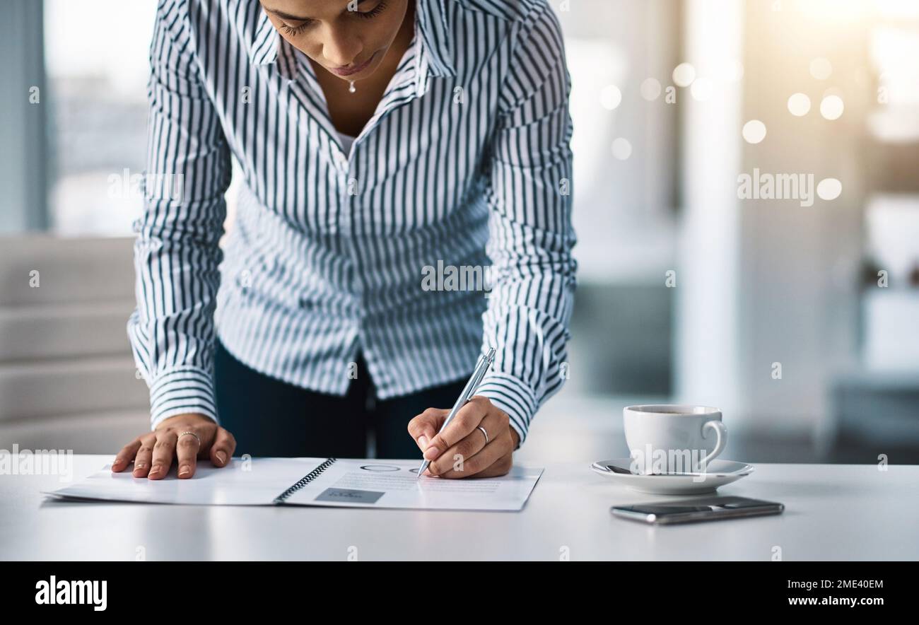 She always plans ahead. a young businesswoman writing notes on a ...