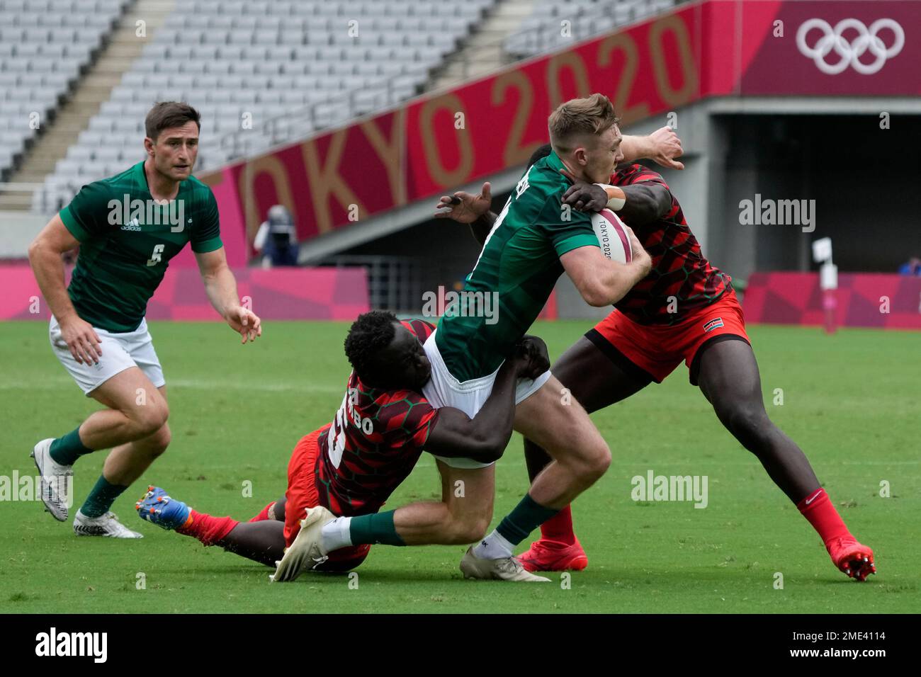 Ireland's Terry Kennedy is tackled by Kenya's Billy Odhiambo, left, and ...