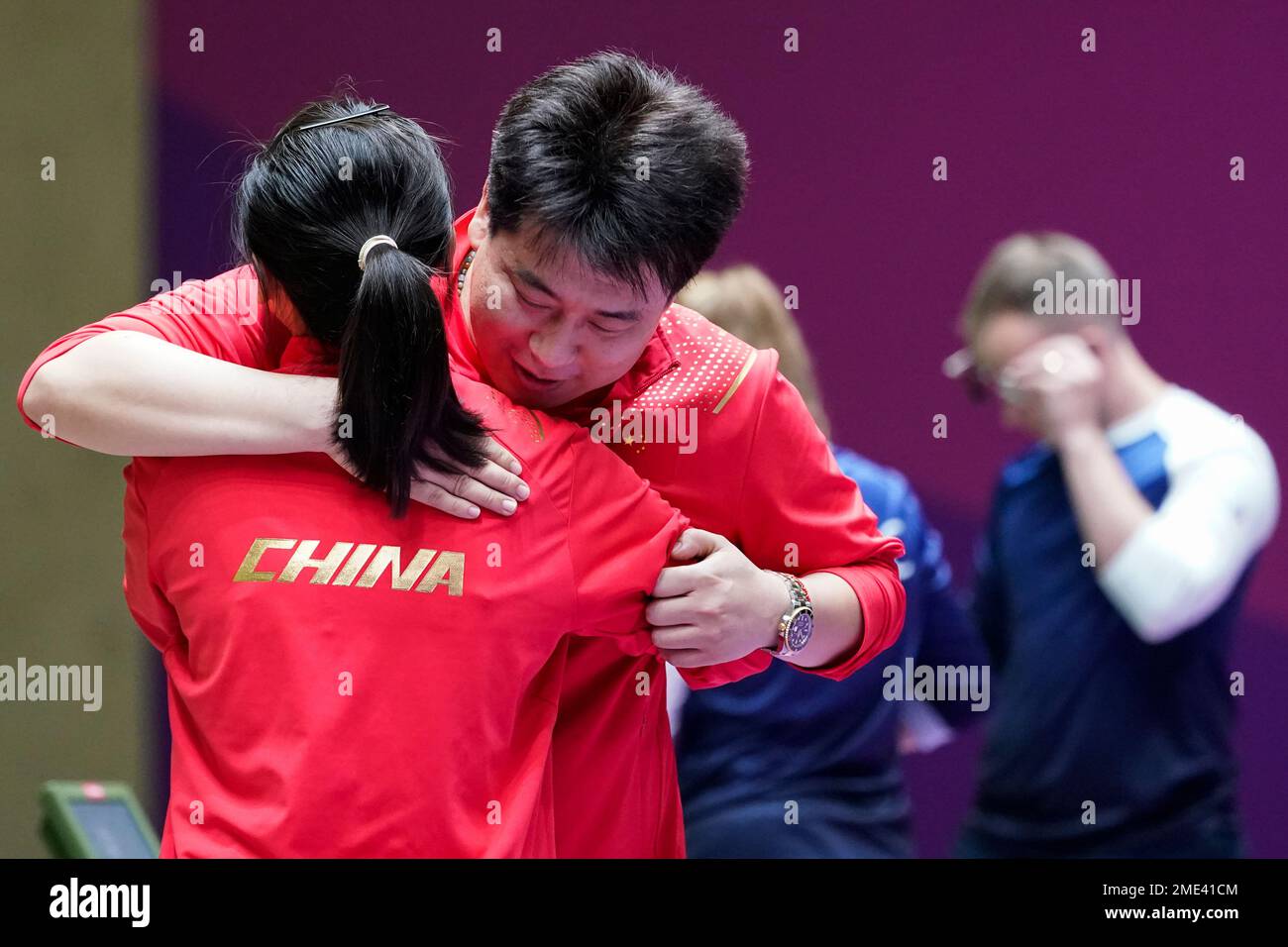 Pang Wei, second from left, hugs, Jiang Ranxin, of China, after the ...