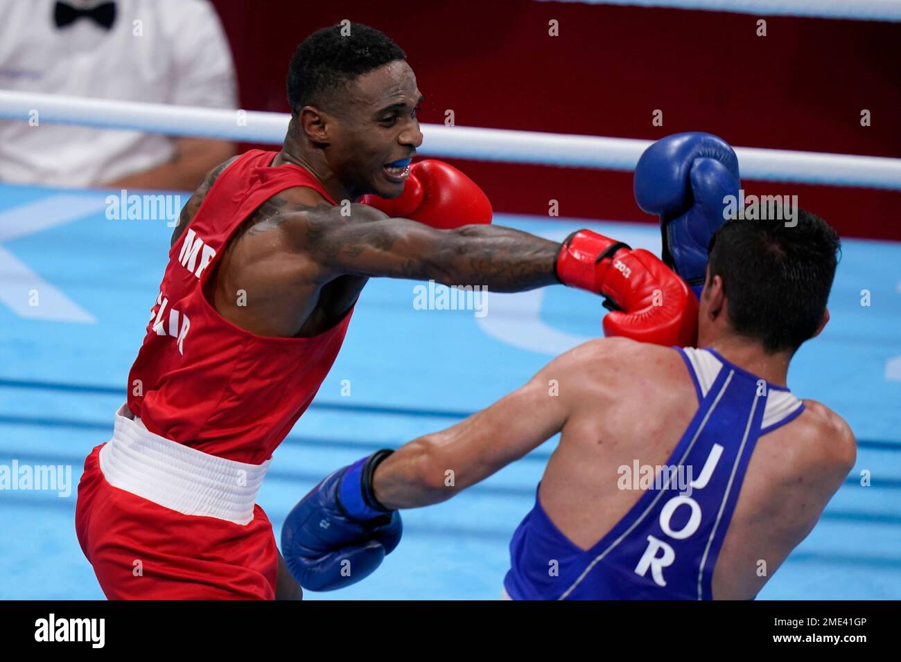 Merven Clair, of Mauritius, left, punches Zeyad Eishaih Hussein Eashash, of Jordan, during their ...